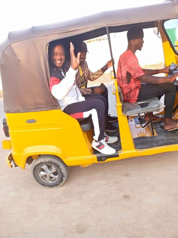 Archbishop Sam Zuga steps out on a tricycle for humanitarian services